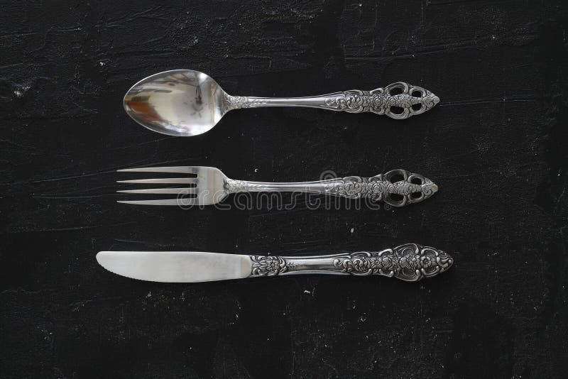 Overhead Shot of Silverware on Black Table with Copy Space. Stock Photo ...