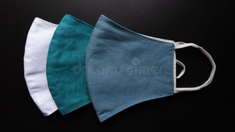 Overhead Shot of Three Different Colored Face Masks on a Black Surface ...