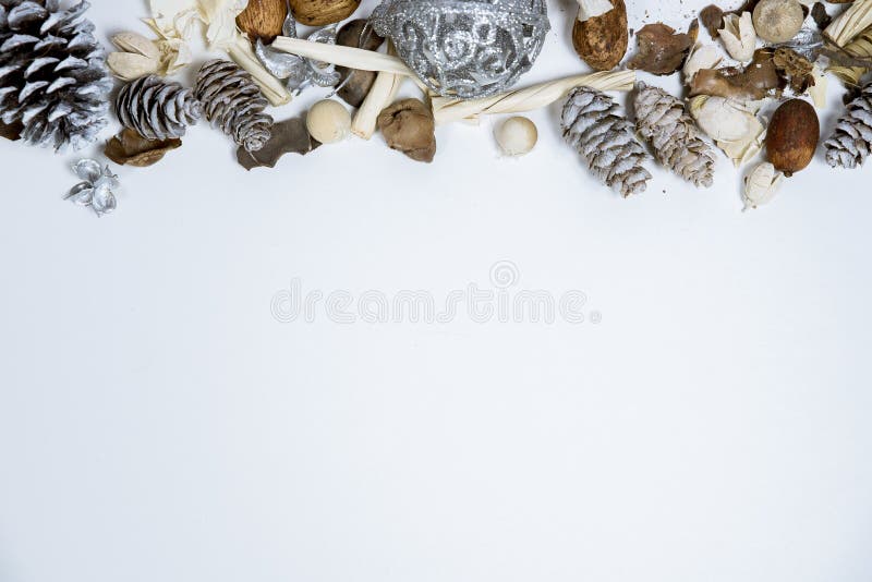 Overhead Shot of a White Surface with Pine Cones and an Ornament on the ...