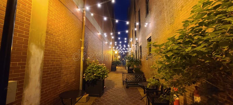 Overhead String Lights in Alleyway Stock Photo - Image of alley, house ...
