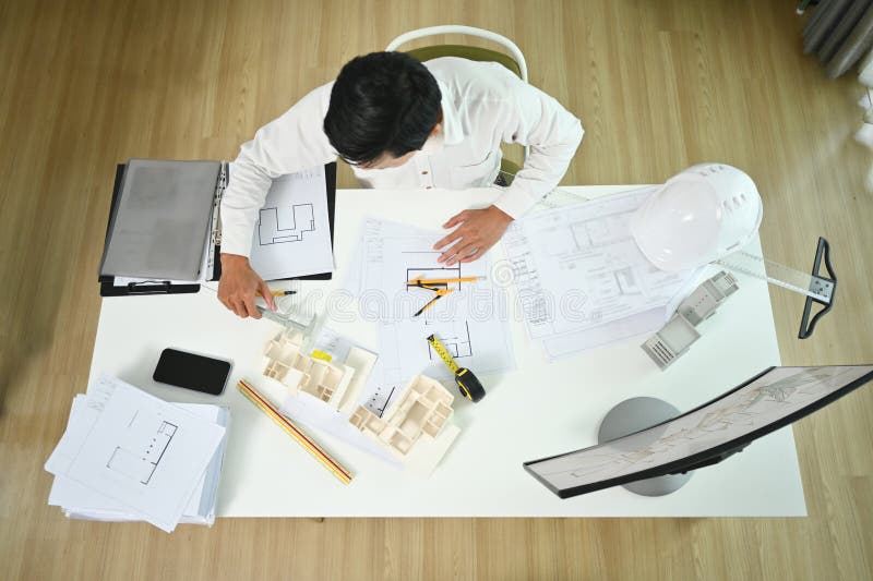 Overhead View of Architect Man Examining House Model while Working ...
