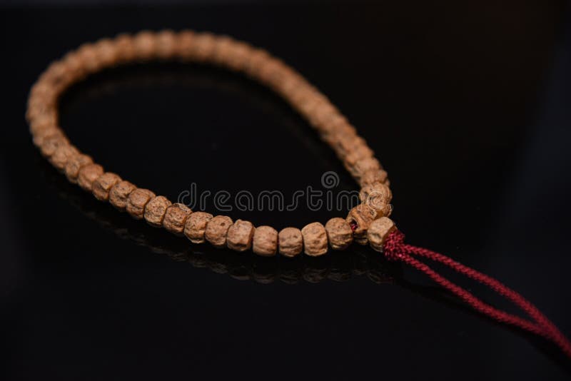 Overhead View of Bodhi Prayer Beads with a Red String on a Black Table ...