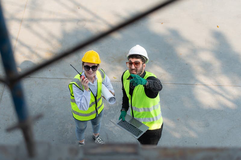 Overhead View on a Building Site, an Engineer and Architect are ...
