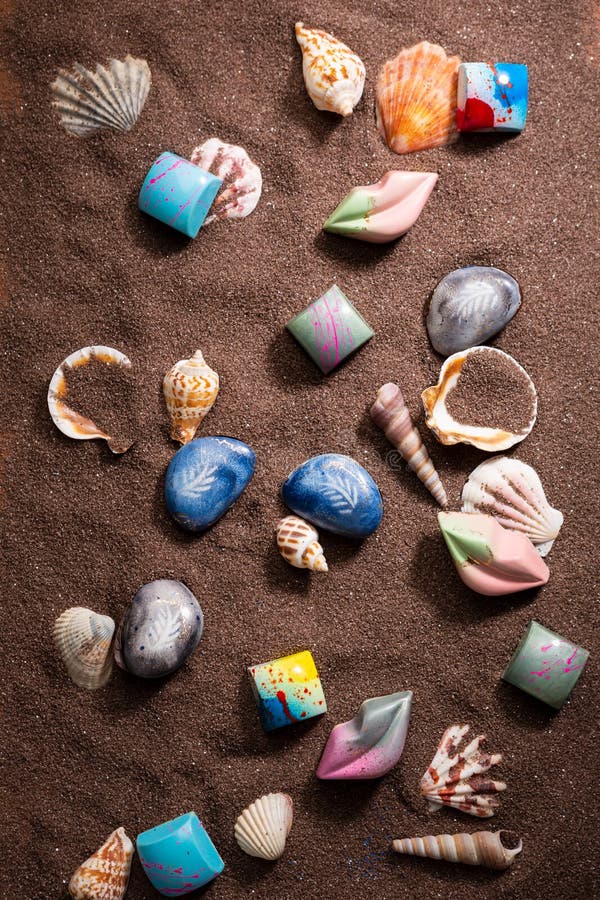 Overhead View of Chocolate Candies and Sand Stock Photo - Image of ...