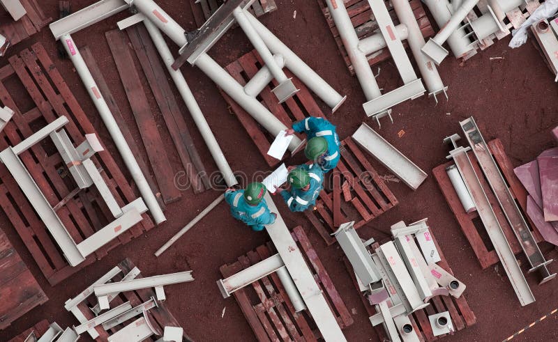 Overhead View of Construction Workers Discuss Plans To Build Stock ...
