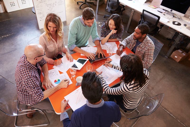 Overhead View of Designers Having Meeting Around Table Stock Photo ...