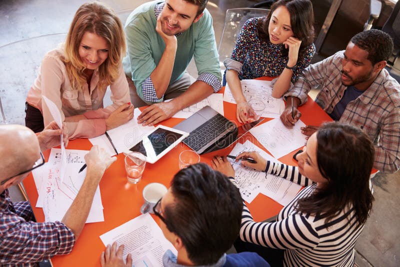 Overhead View of Designers Having Meeting Around Table Stock Image ...