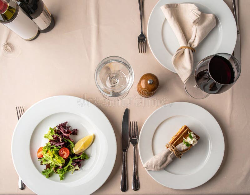Overhead View of Elegant Table Setting with Salad Wine and Water on ...