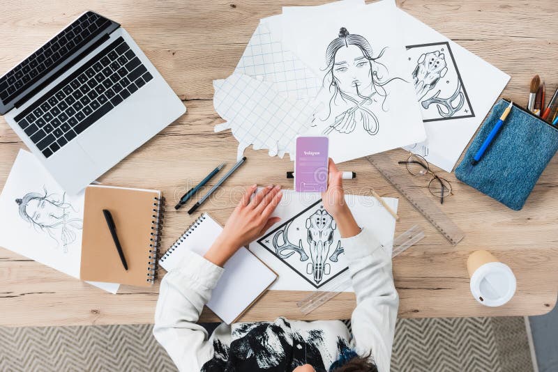 Overhead View of Female Designer Using Smartphone with Instagram ...