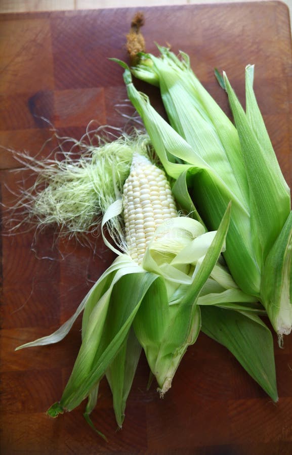 Two Ears of Corn on Cutting Board Stock Photo - Image of sweet ...
