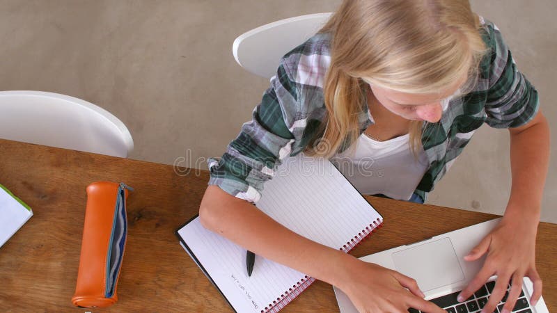 Overhead View of Girl Doing Homework at Table on Laptop Stock Video ...