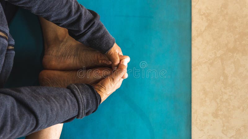 Overhead View of Hands Holding Feet during a Stretch in Yoga Practice ...