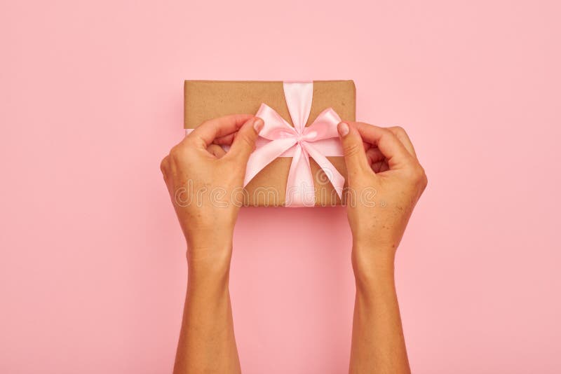 Hands Tying Pink Bow on a Present Box Stock Image - Image of package ...