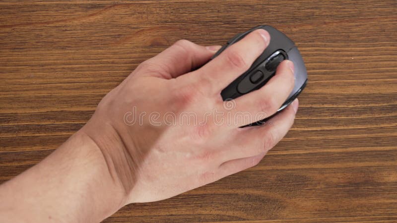 Overhead View of Hands Using a Black Computer Mouse on Wooden Surface ...