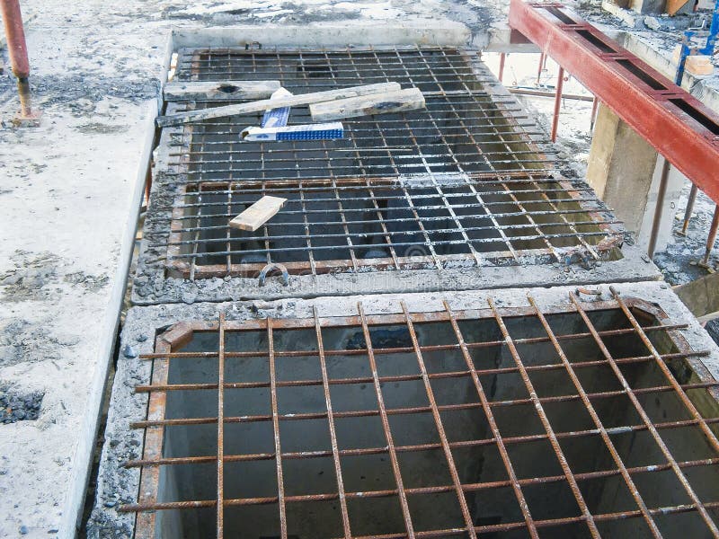 An Overhead View Highlights Metal Grating Over Concrete Pits within a ...