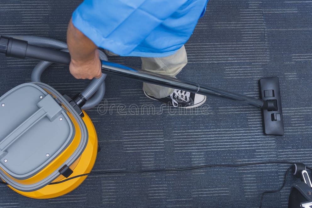 Overhead View of a Janitor Using a Vacuum Cleaner on a Carpet ...