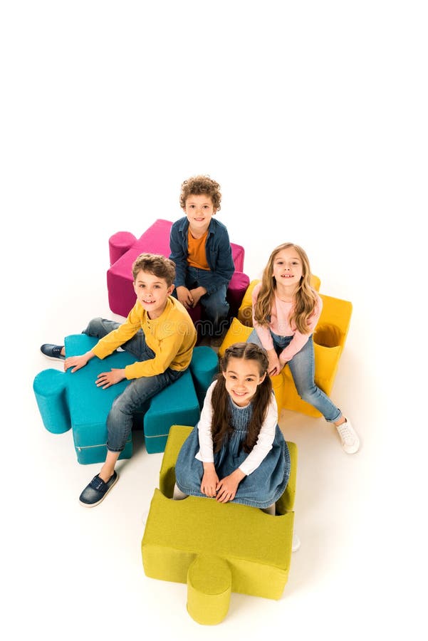 Overhead View of Kids Sitting on Jigsaw Puzzles on White. Stock Image ...