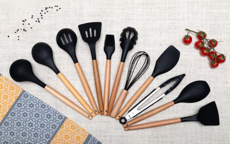 Kitchen Utensils Laid Out on a Cloth with Cherry Tomatoes in the ...