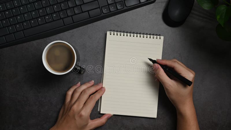 Overhead View of Man Hand Holding Pen and Writing on Blank Notebook ...
