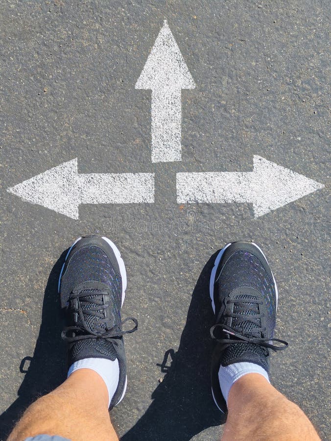 Overhead View of Man& X27;s Feet Standing before Three Direction Arrows ...