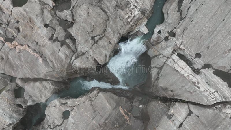 Overhead View of a Narrow Waterfall Forcefully Flowing through Jagged ...