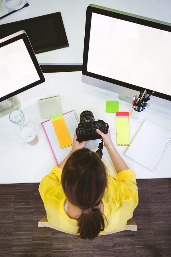 Overhead View of Photographer with Camera Sitting at Creative Office ...