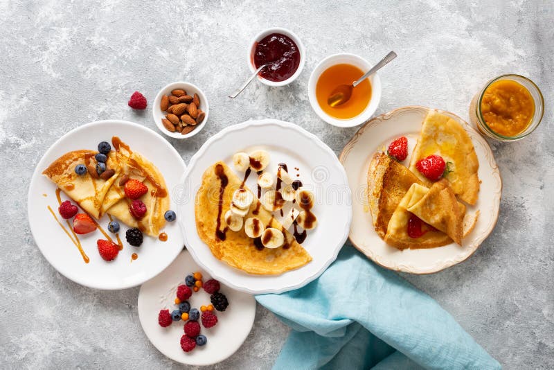 Overhead View of Plate with Breakfast Crepes and Berries, Three Plates ...