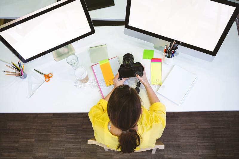 Overhead View of Professional Sitting with Camera at Desk in Creative ...