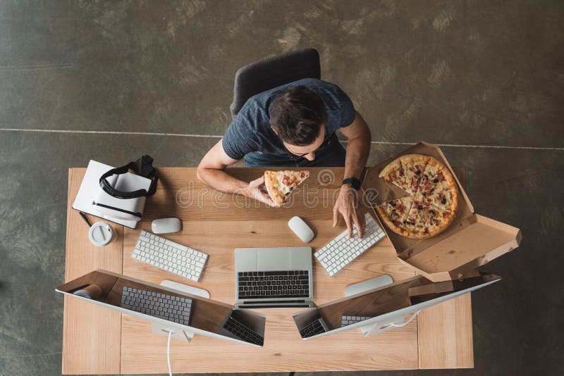 Overhead View of Programmer Eating Pizza and Using Computers Stock ...