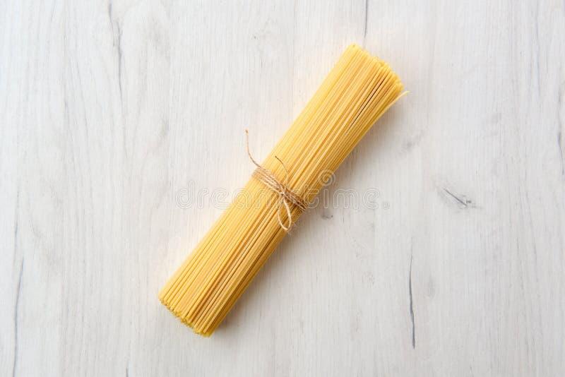 Overhead View of Raw Spaghetti on Wooden Table Stock Photo - Image of ...