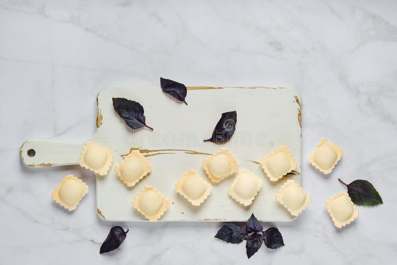 Overhead View of Raw Uncooked Ravioli on a Chopping Board Stock Photo ...