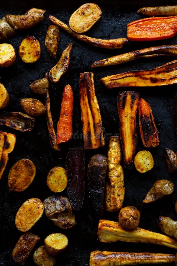 Overhead View of Roasted Roots on Black Surface Stock Image - Image of ...