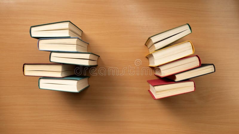 An Overhead View of Rows of Books with Colored Covers on a Wooden Table ...