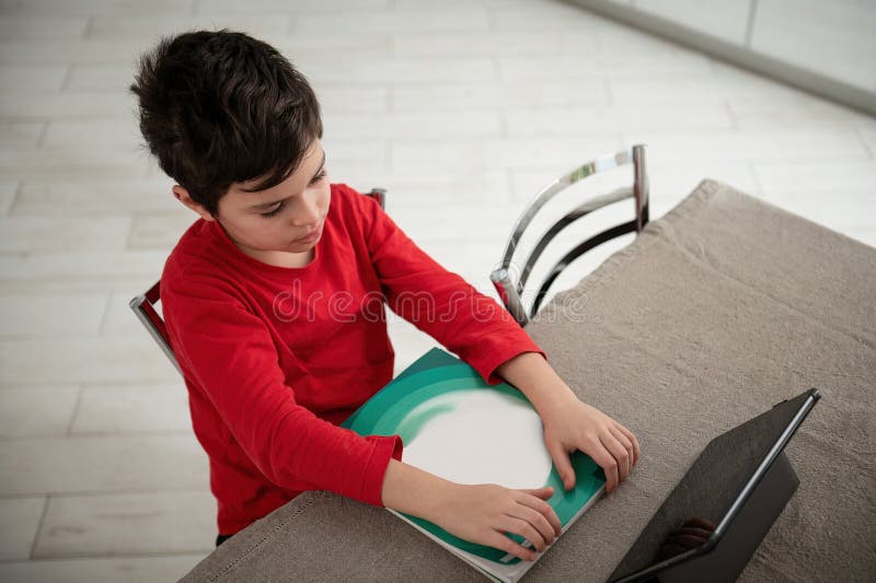 Overhead View of a School Child Doing Homework, Using Digital Tablet To ...