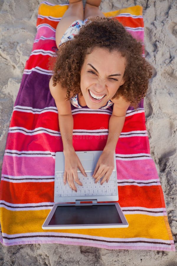 Overhead View of a Smiling Woman Looking at the Camera while Using Her ...