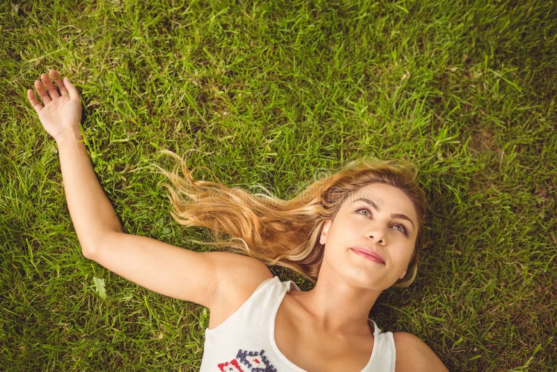 Overhead View of Smiling Woman Lying on Grass Stock Image - Image of ...