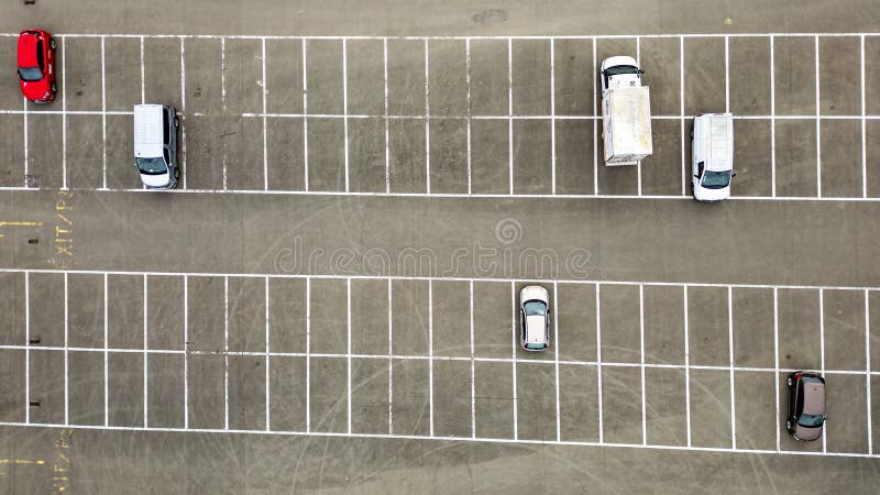 Overhead View of Sparse Parking Lot with Vehicles in Marked Spaces ...