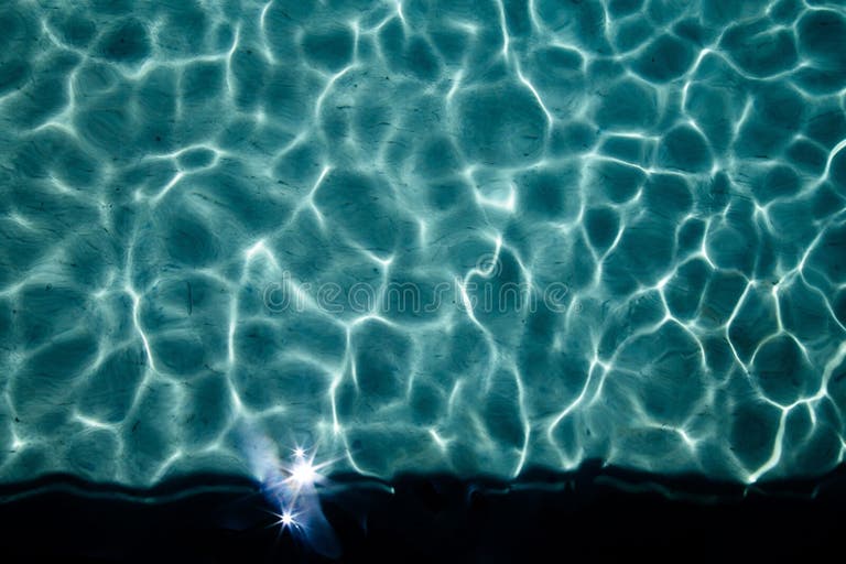 Overhead View of the Surface of a Blue Pool with the Sun Creating ...
