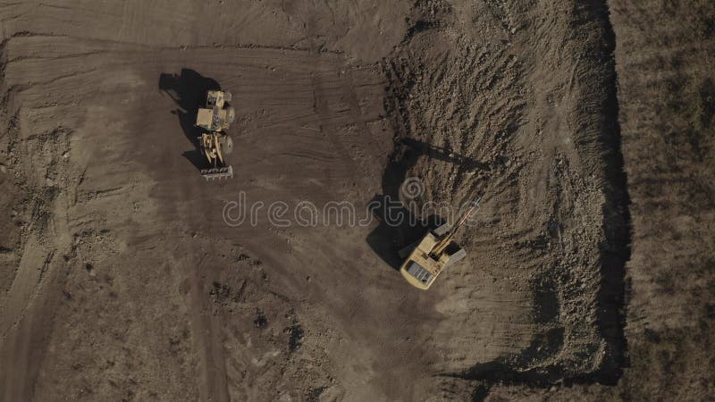 Overhead View of Tractor and Excavator Doing Earthwork at Construction ...