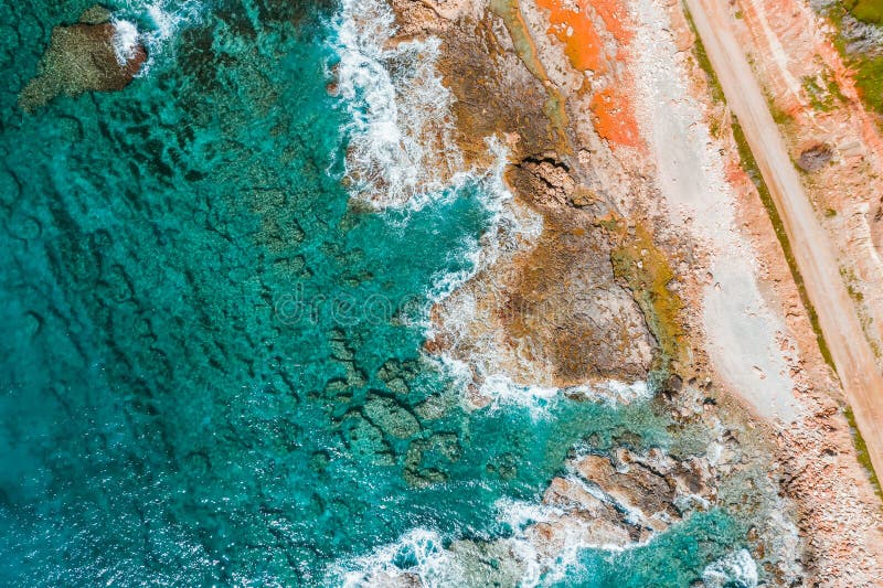 Overhead View of Turquoise Sea, Waves and a Rocky Shoreline Stock Photo ...