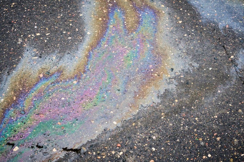Overhead View of a Vibrant Oil Slick on Wet Asphalt. Stock Image ...