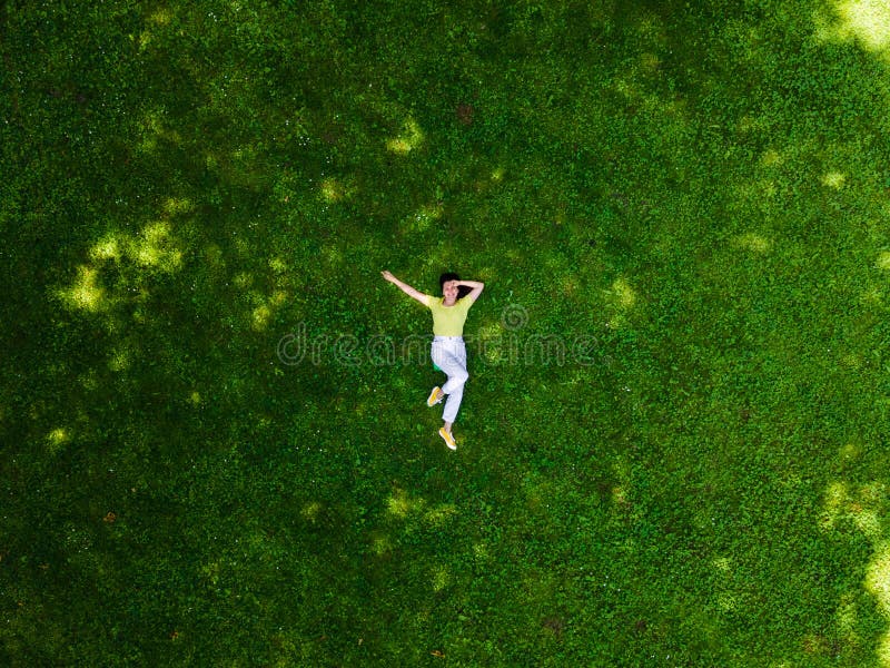 Overhead View of Woman Laying Down on Green Grass Stock Photo - Image ...