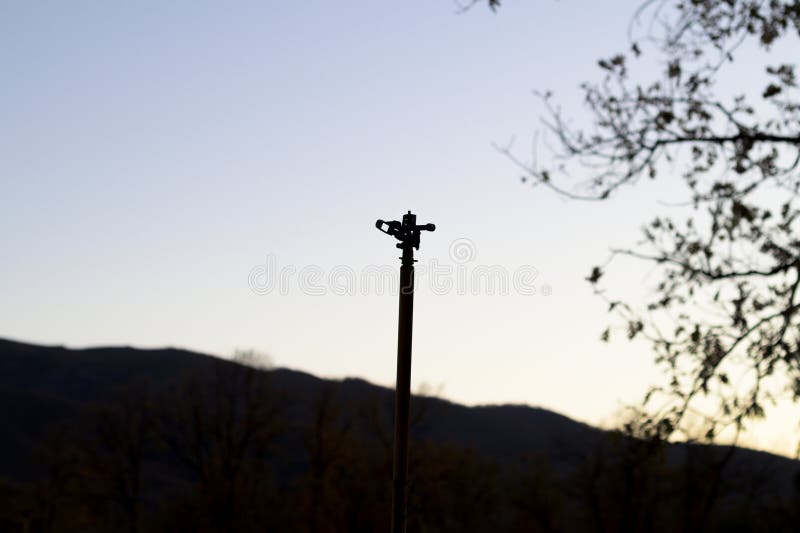 Overhead Water Sprinkler Standing Backlit with Clear Sky and Drought ...