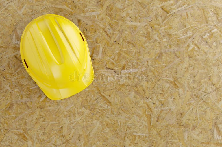 Overhead View of Yellow Hard Hat on Particleboard with Room for Text ...