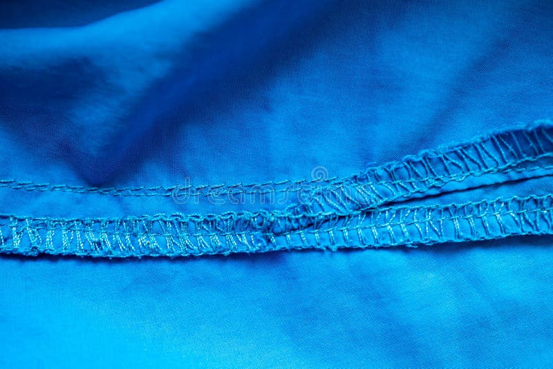 Overlock Seam on Blue Fabric. Textured Cloth Background. Place for Text ...