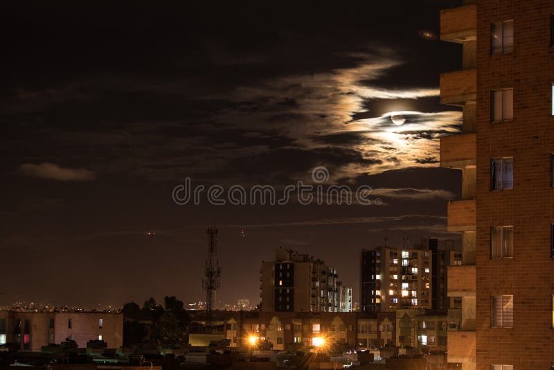 Overnight in the City with the Cloudy Sky and the Moon As the ...