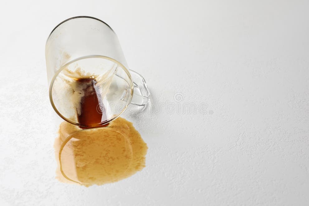 Overturned Cup and Spilled Coffee on Light Table. Space for Text Stock ...