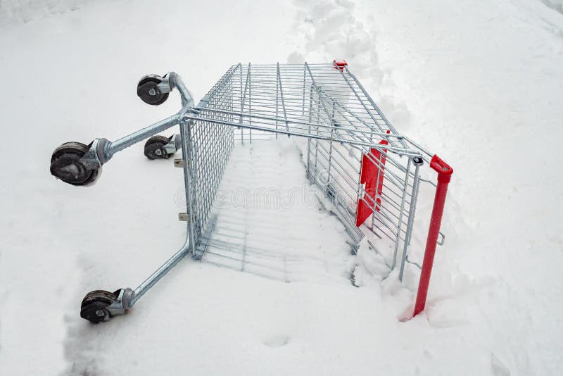 An Overturned Empty Shopping Cart in the Snow. the Concept of a ...