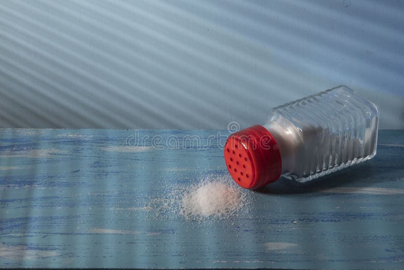 Overturned Salt Shaker with Salt on the Side Stock Photo - Image of ...