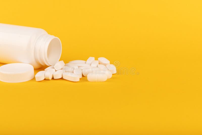 Spilled White Medication Bottle with Scattered Tablets on a Bright ...